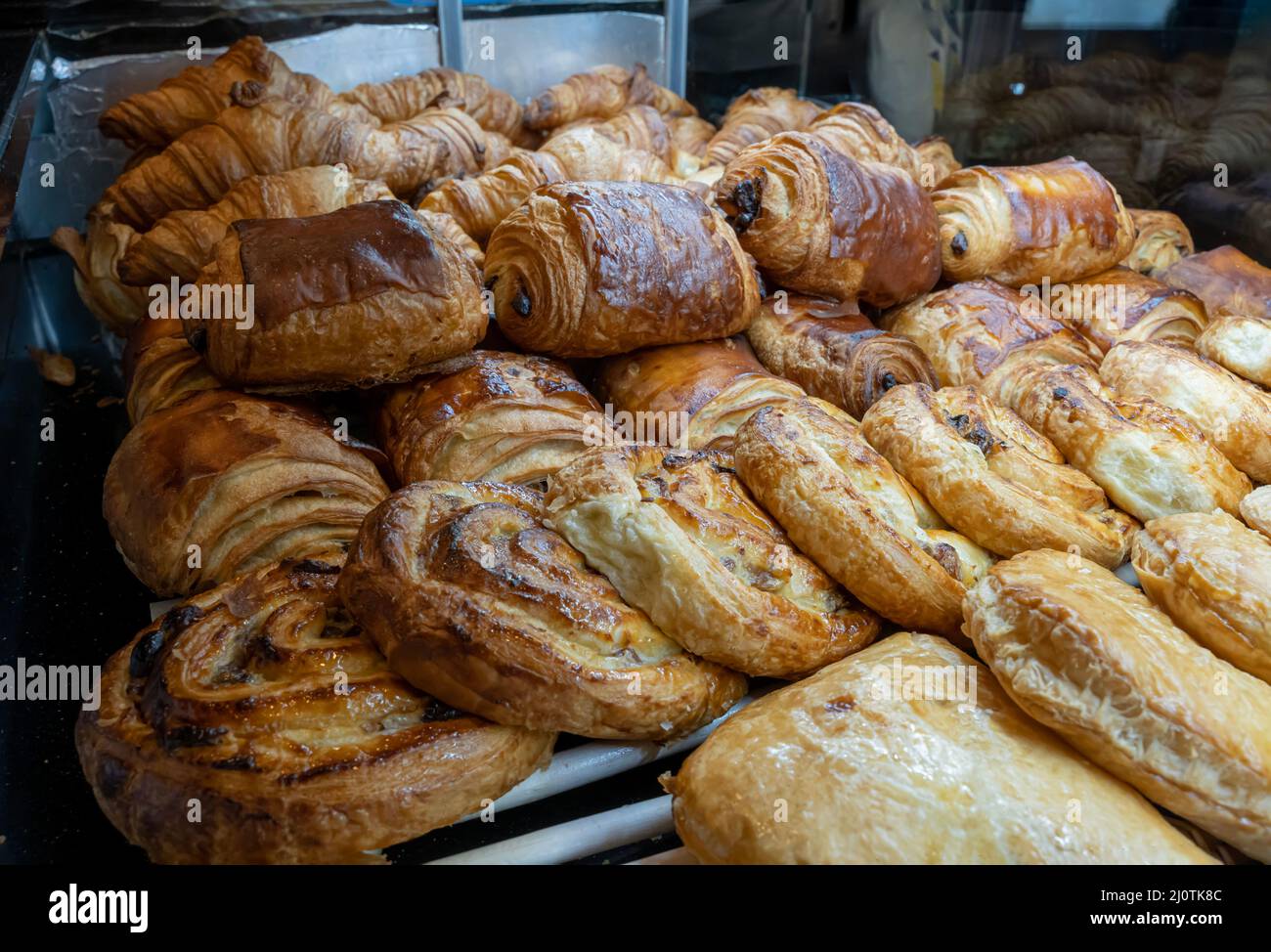 Artisan baker and pastry chef. Detail of mixed pastries in a bakery ...