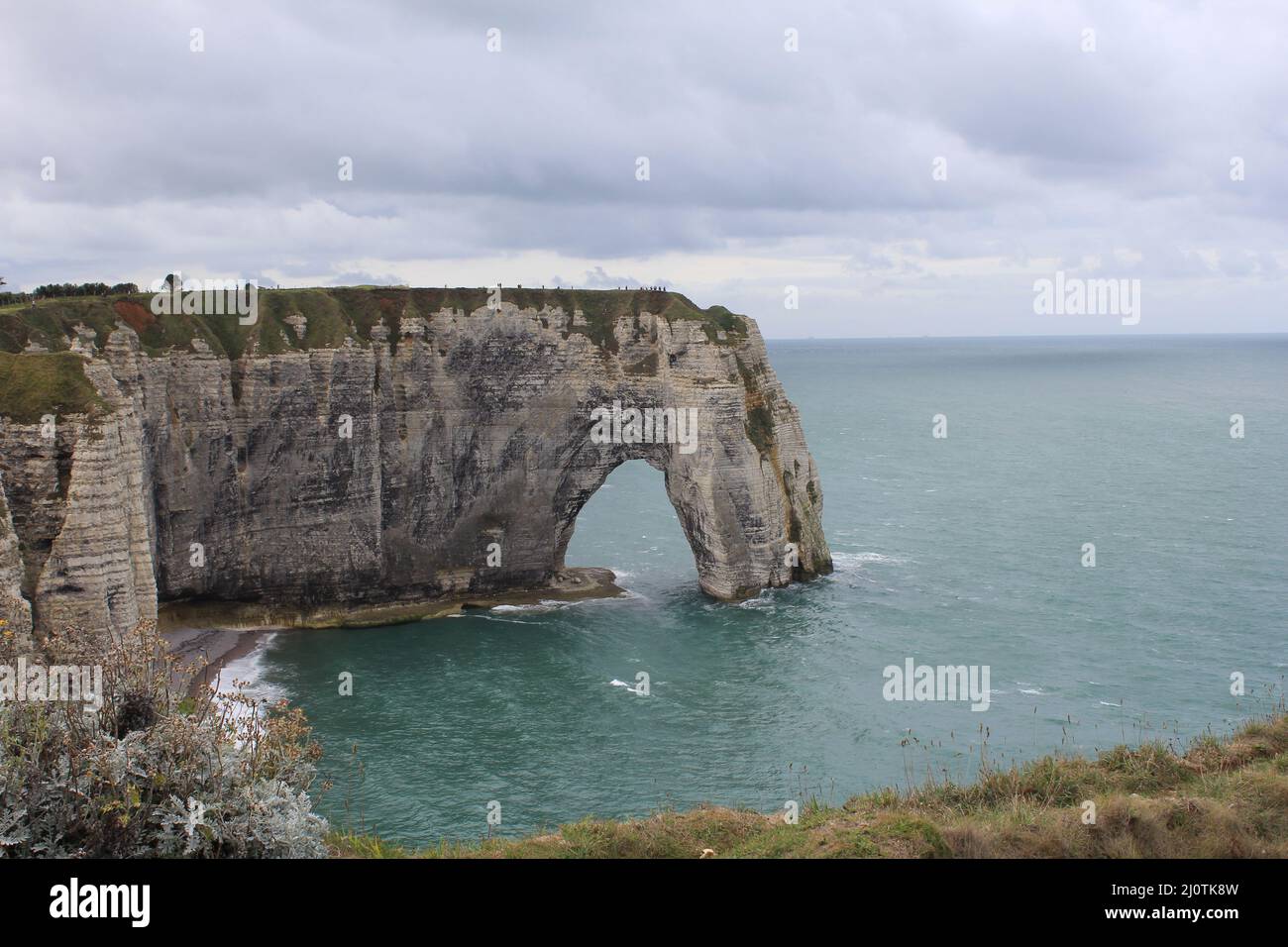 white cliffs with an arch in the sea in etretat, at the french coast in ...