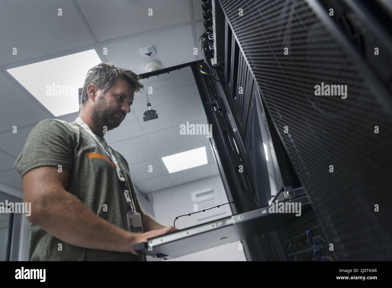 Close up on Data Center Engineer hands Using keyboard on a ...