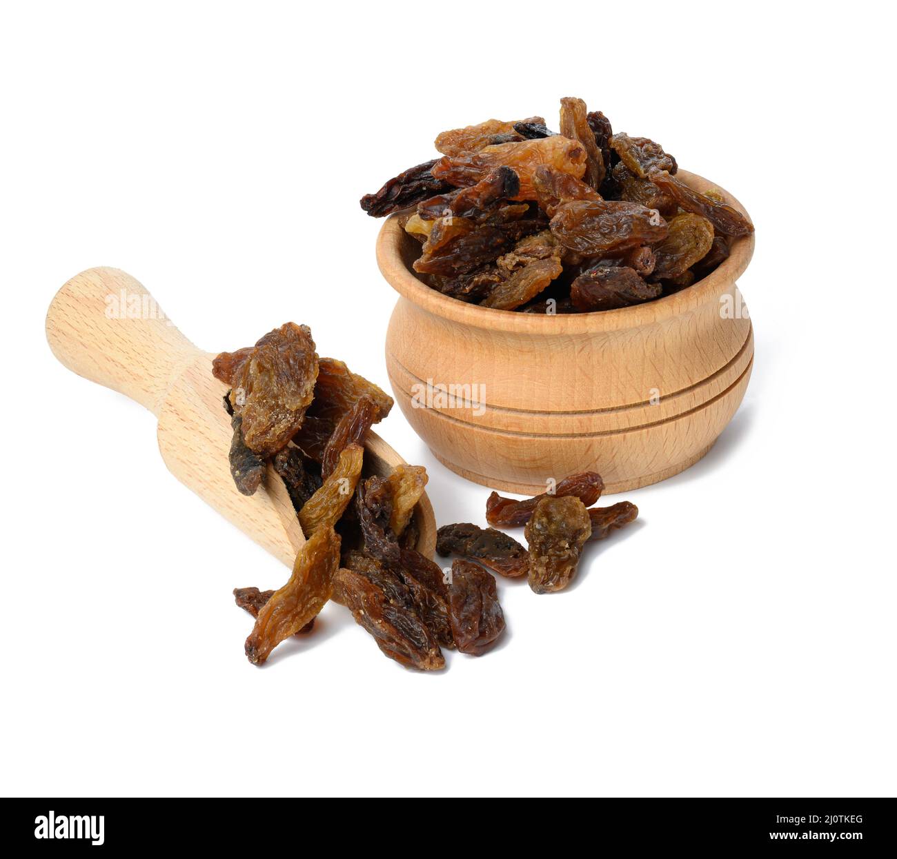Dried brown raisins in wooden bowl and spoon isolated on white ...