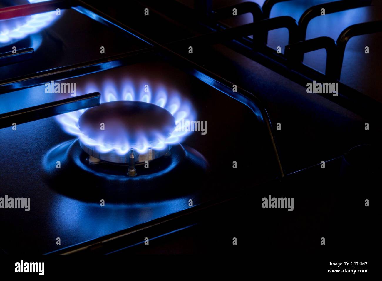 Gas burner with blue burnig methane flame on dark background Stock ...