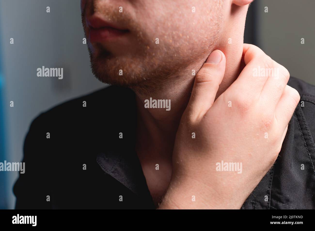 Holding his neck hi-res stock photography and images - Alamy