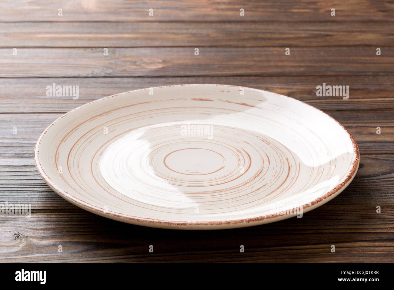 Perspective view of empty colorful plate on cement background. Empty ...