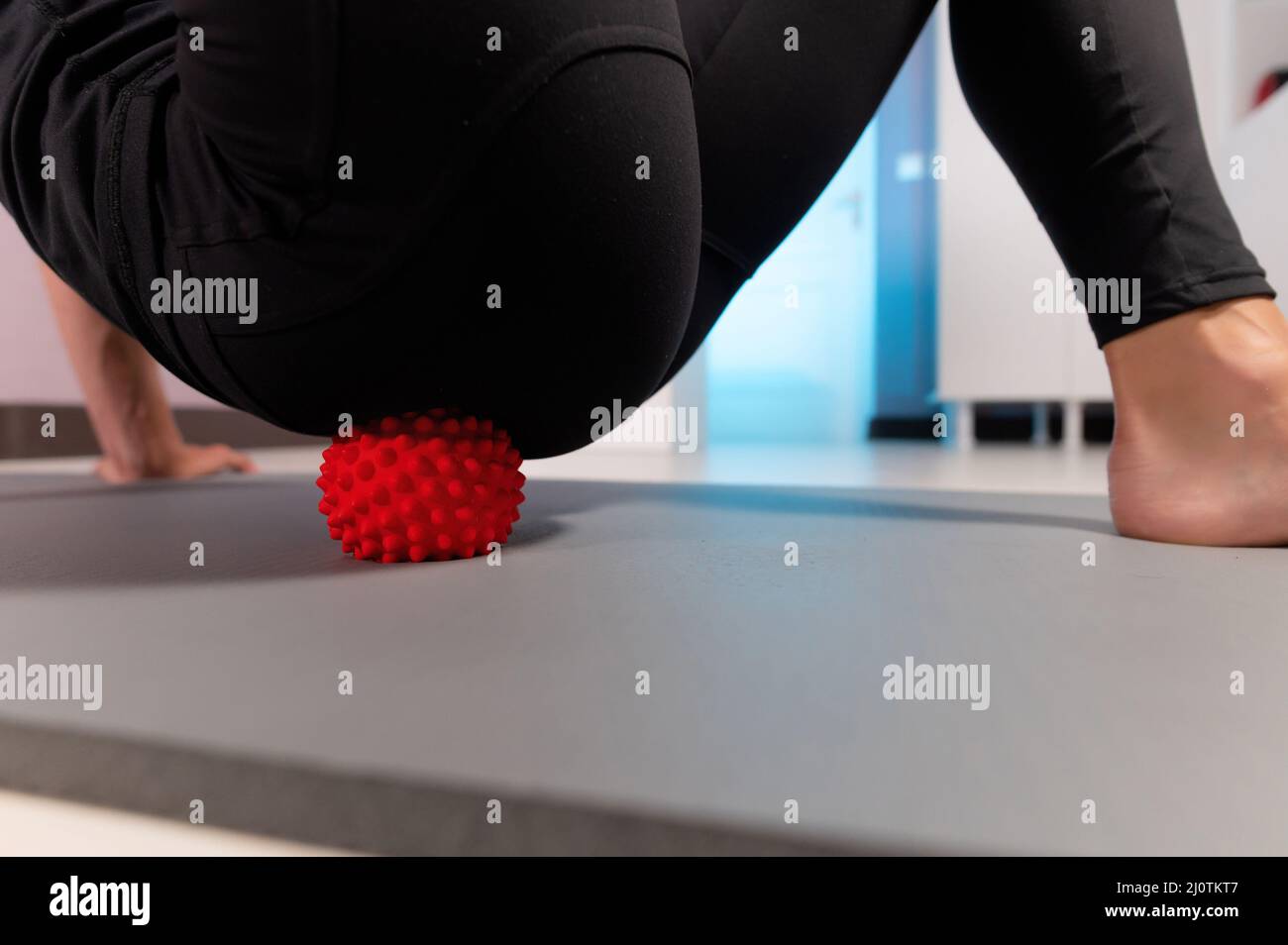 Close-upAthletic caucasian slim woman doing myofascial self-massage of ...