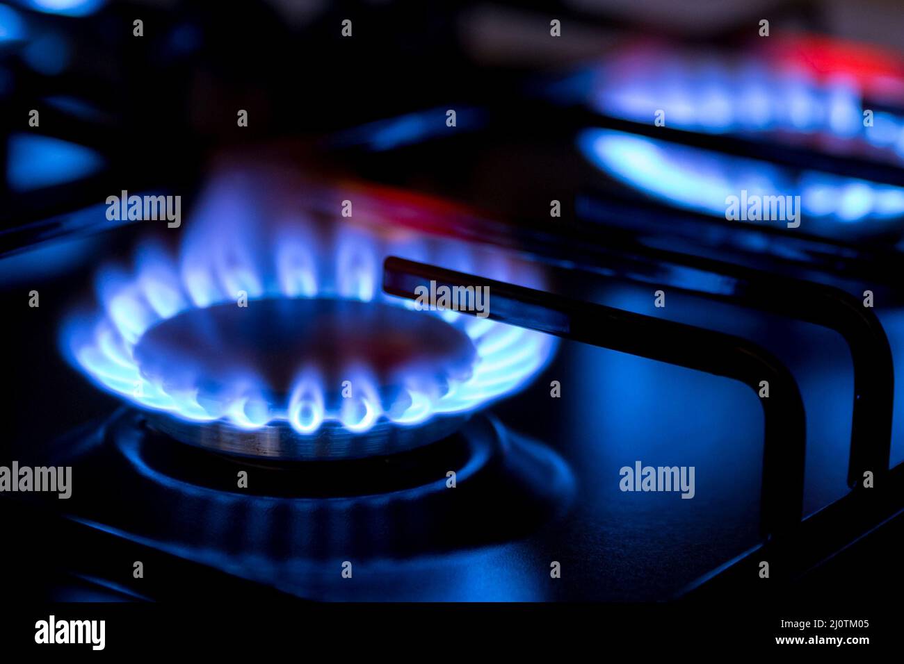 Gas burner with blue burnig methane flame on dark background Stock ...