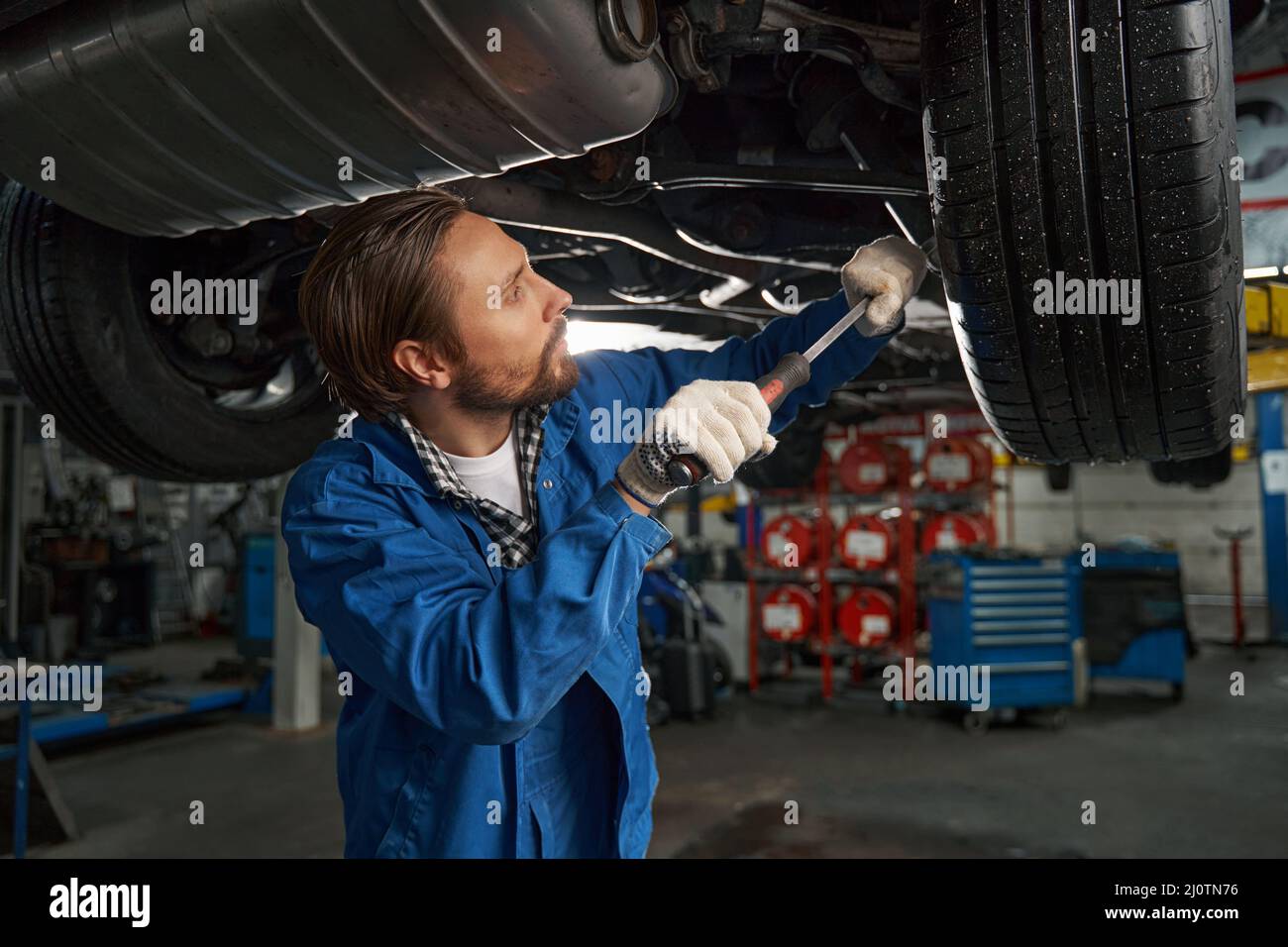 Close-up photo of car mechanic working at service station Stock Photo ...