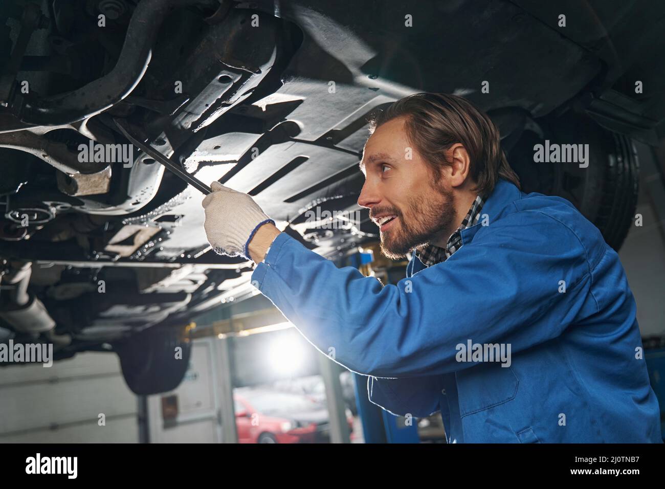 Close-up photo of man working at service station Stock Photo - Alamy