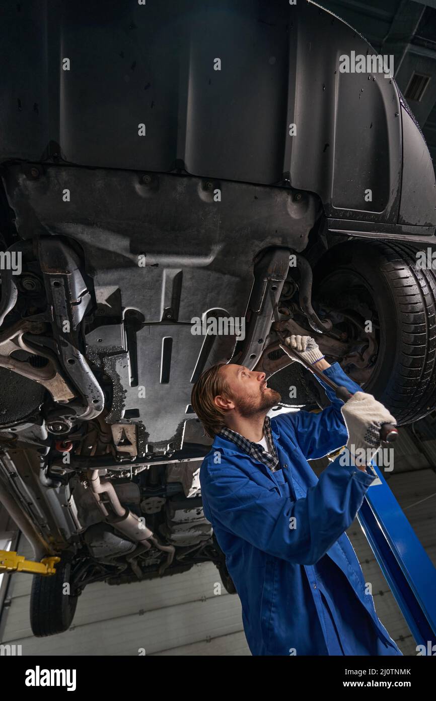 At service station male working and repairing car Stock Photo - Alamy