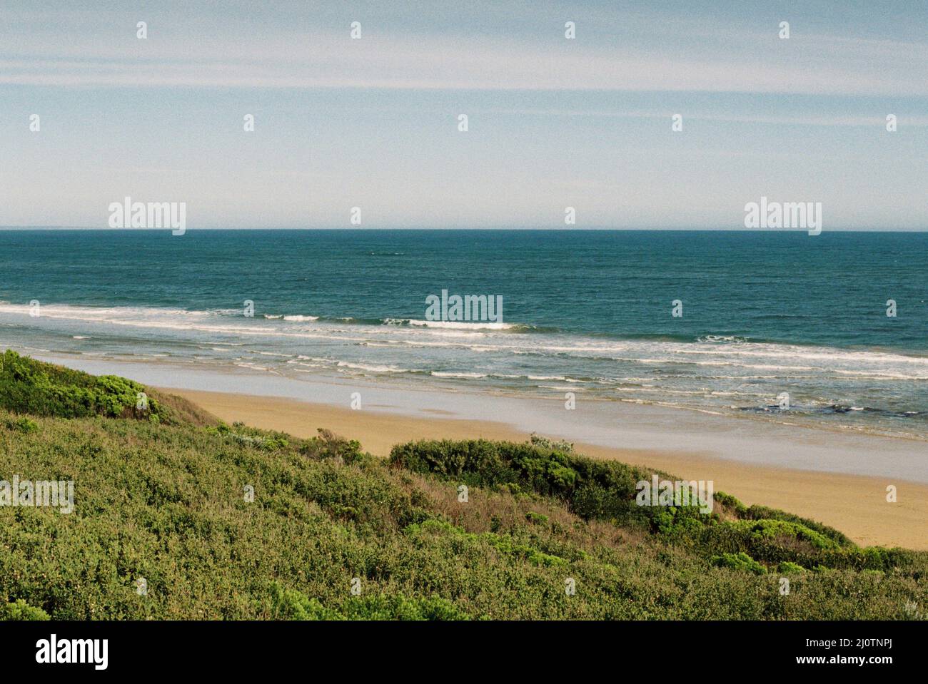 Beautiful sunny empty beach with sea waves Stock Photo - Alamy