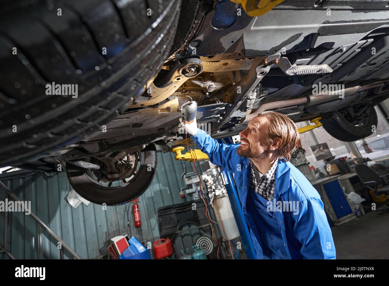 Man holding lamp and performing machine diagnostics Stock Photo - Alamy