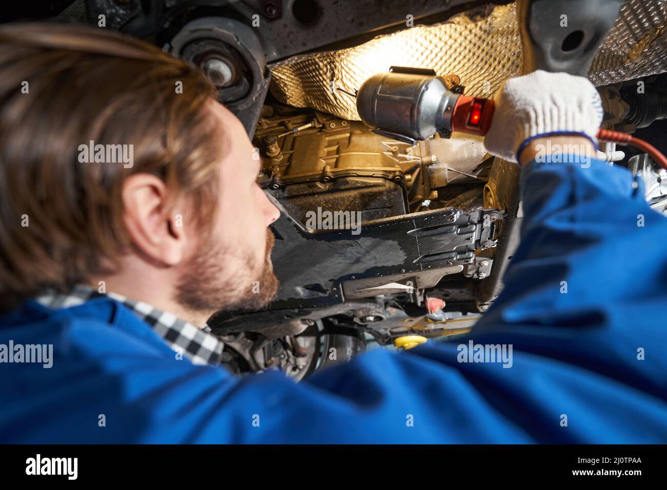 Man holding lamp and performing machine diagnostics Stock Photo - Alamy