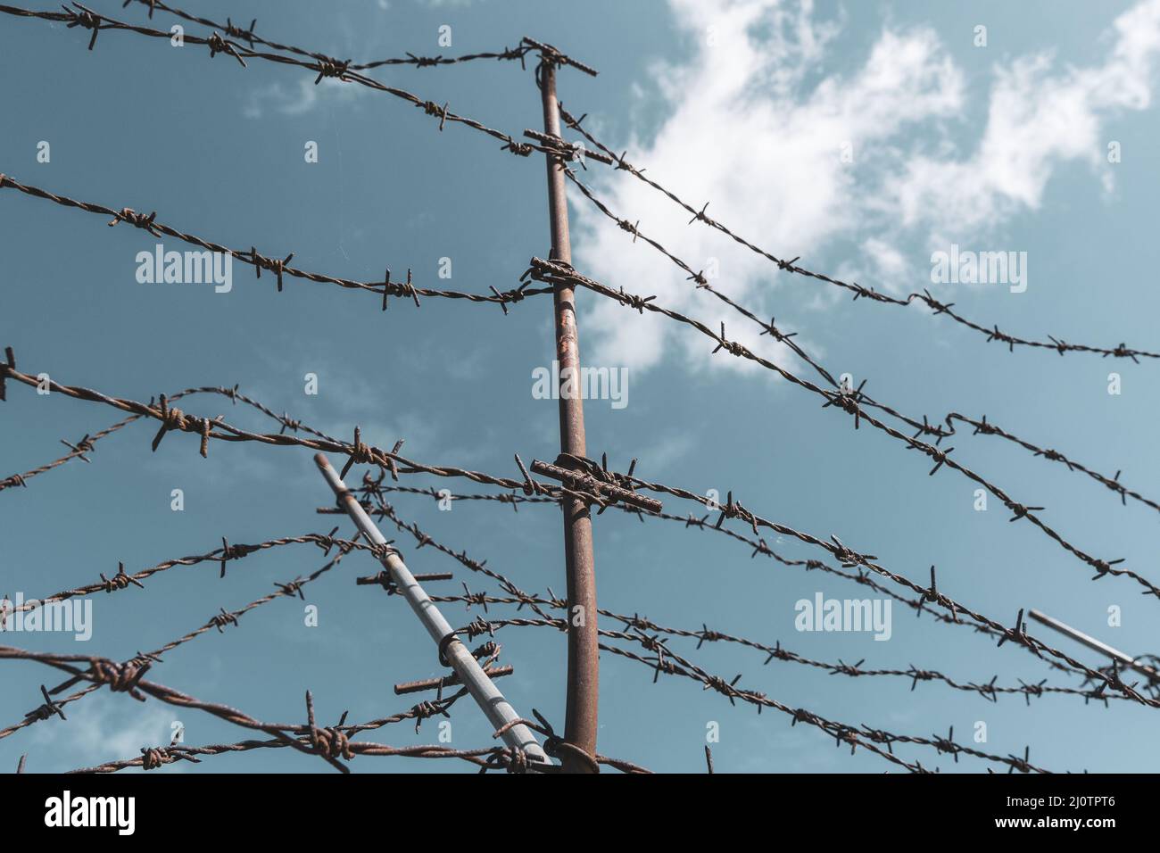 Barbed wire fencing against sky background Stock Photo - Alamy