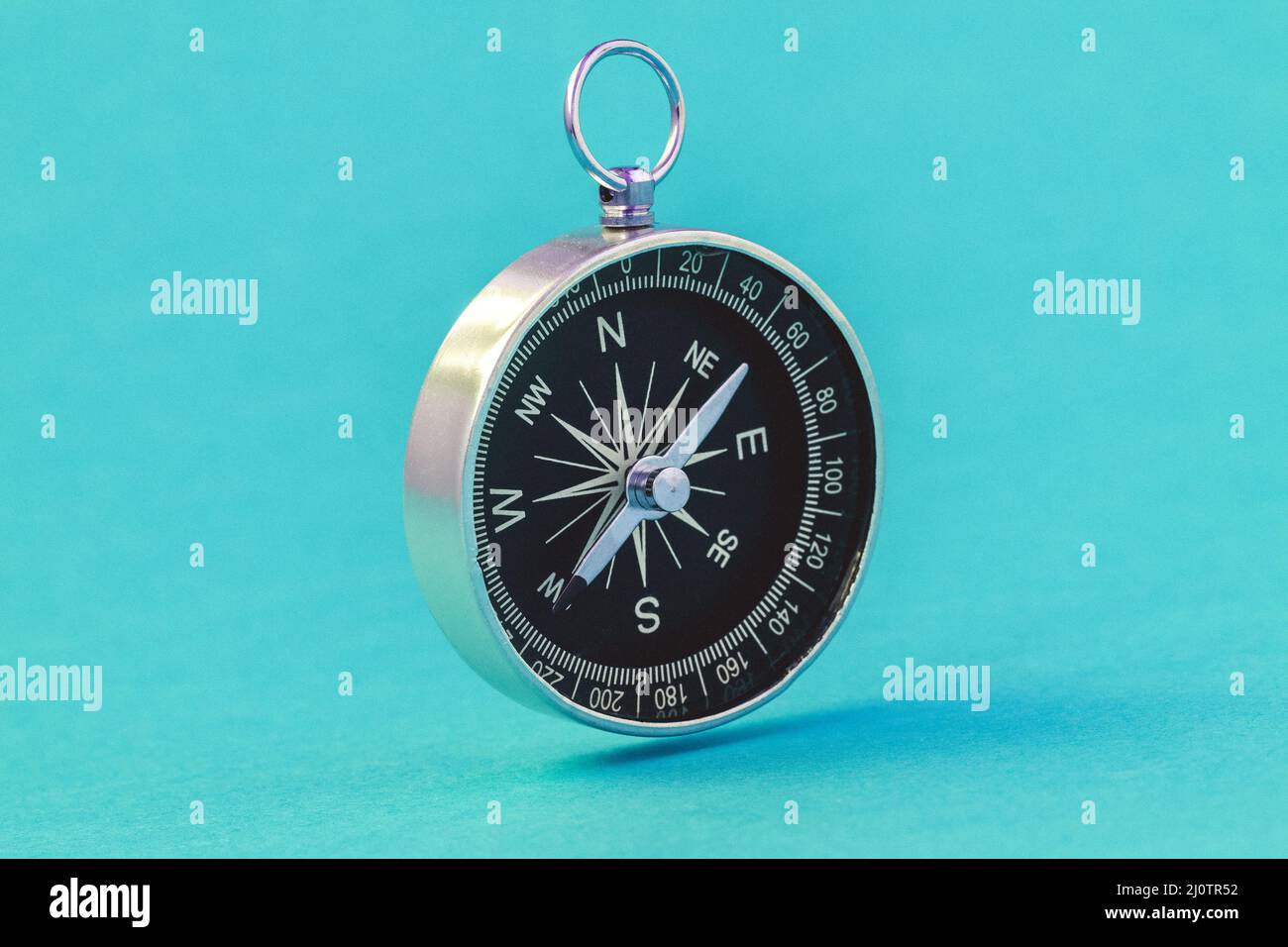 Black compass floating on the blue background Stock Photo - Alamy