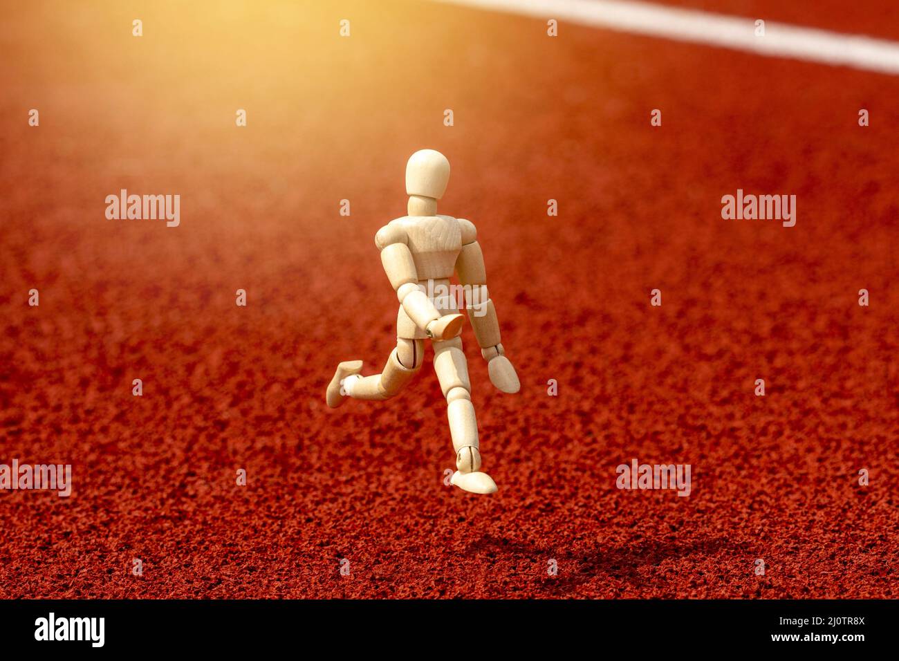 Wooden figure running on the stadium track Stock Photo - Alamy