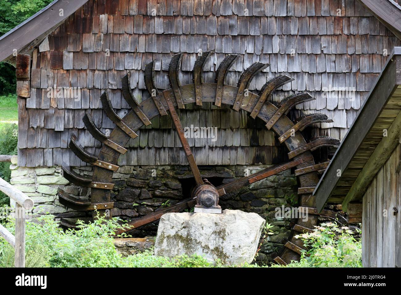 Old metal water wheel in the village Stock Photo - Alamy