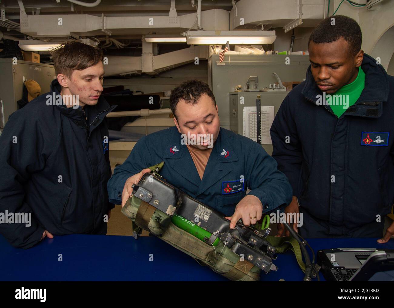 Aircrew Survival Equipmentman Nathan Rios, center, trains Airman Carlos ...