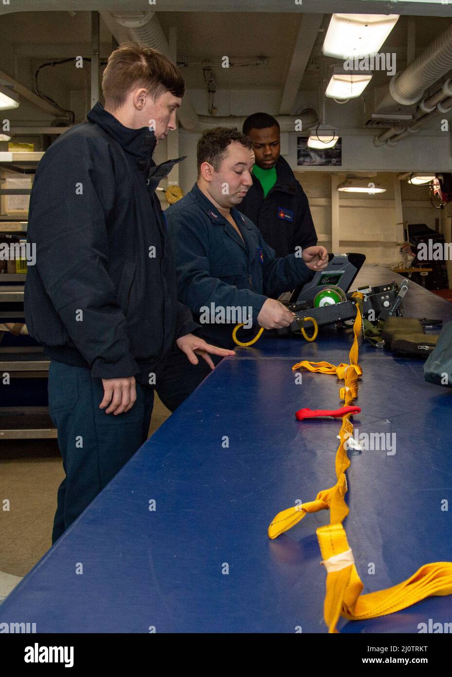 Aircrew Survival Equipmentman Nathan Rios, center, trains Airman Carlos ...