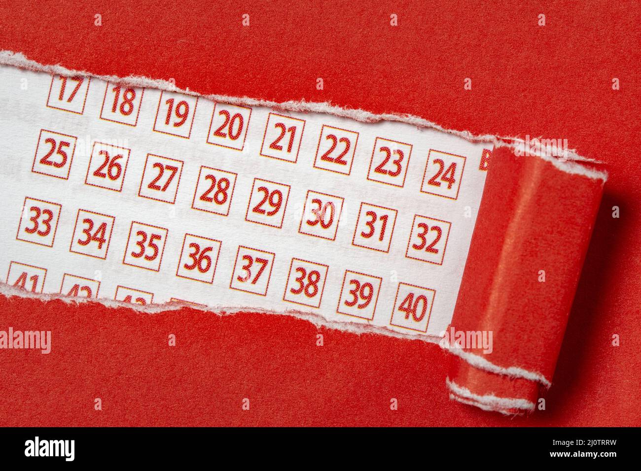 Red paper torn to reveal lottery ticket numbers Stock Photo - Alamy