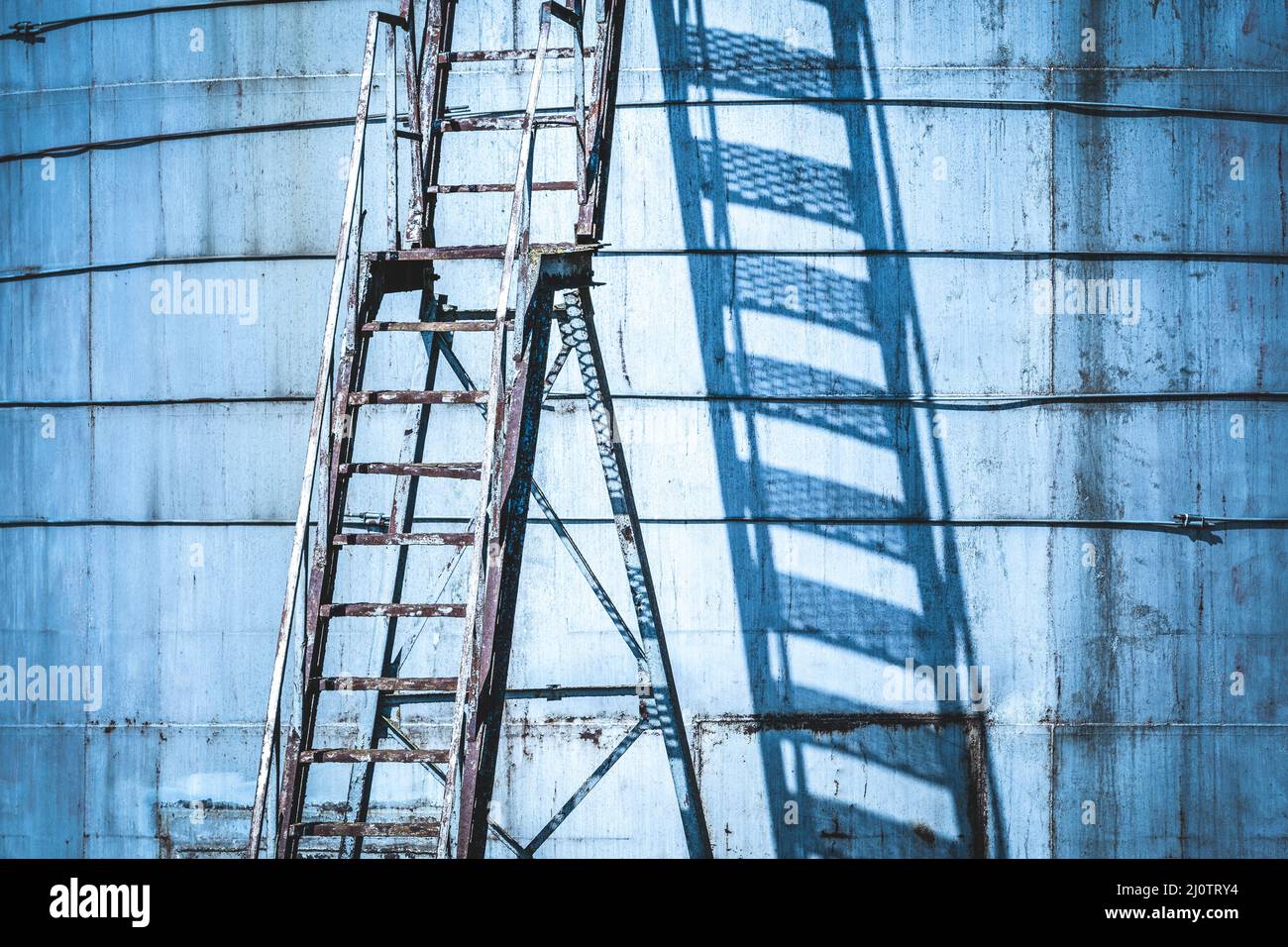 Ladder with access to a large tank in abandoned cargo terminal Stock ...