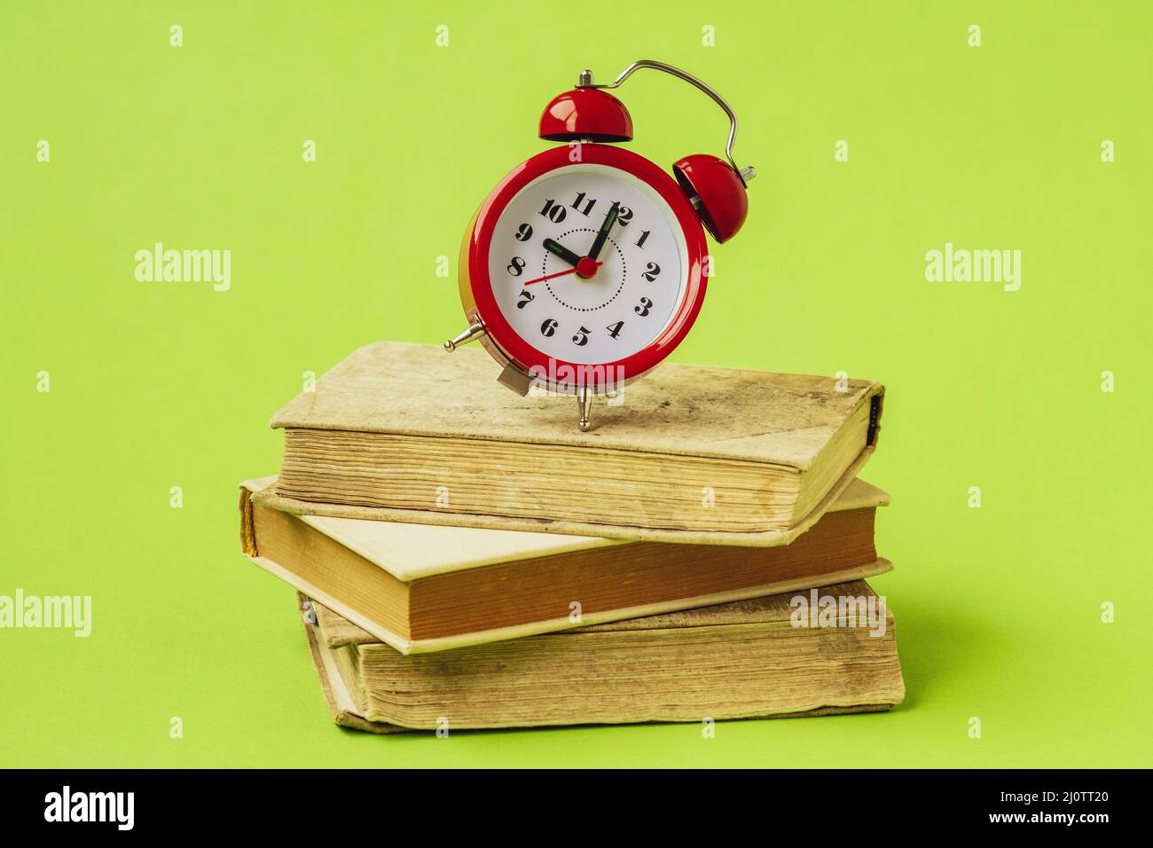 Stack of books with alarm clock Stock Photo - Alamy