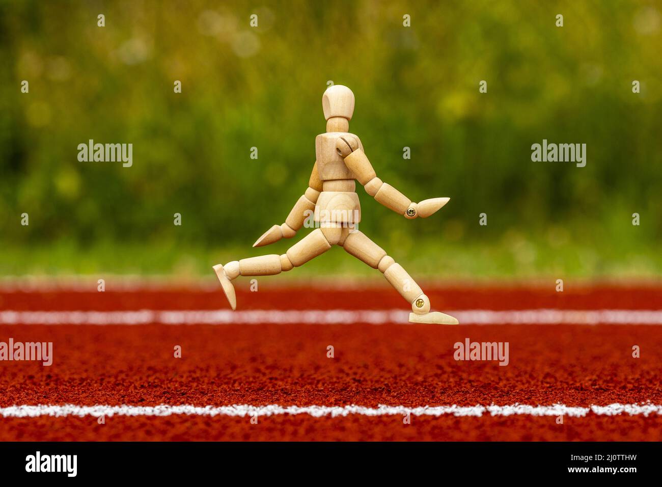Wooden man running on the stadium track Stock Photo - Alamy