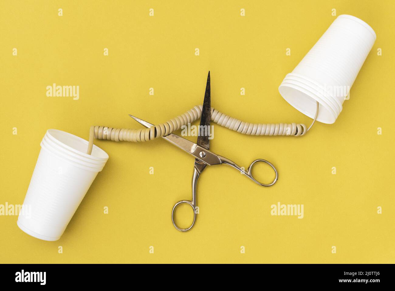 Can phones on yellow background with the cord got cut off Stock Photo ...