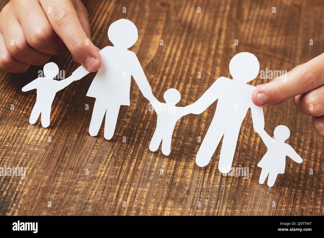 Child holding cutout paper chain family Stock Photo - Alamy