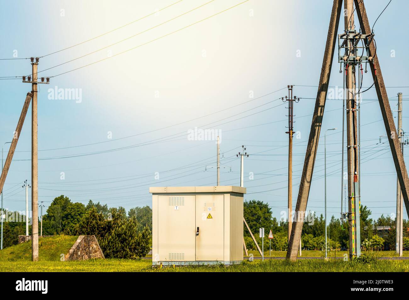 Electric high voltage cabinet surrounded by power pylons Stock Photo ...