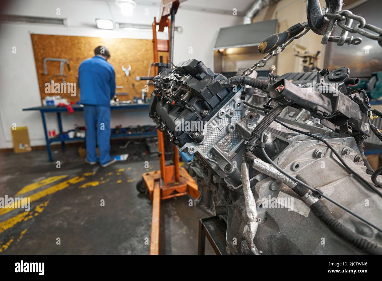 Mechanic working near the table in the garage Stock Photo - Alamy