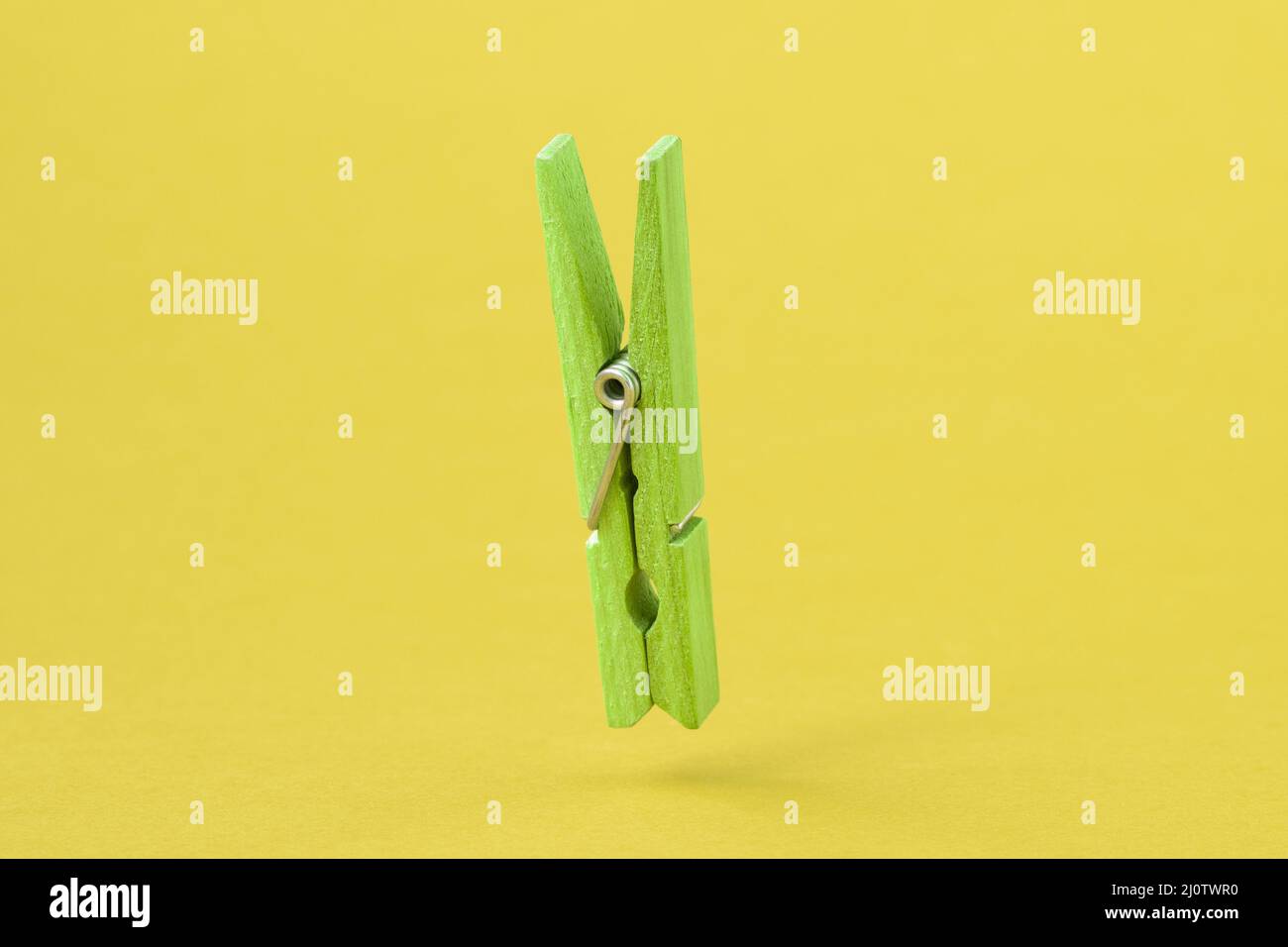 Green wooden clothes peg Stock Photo - Alamy