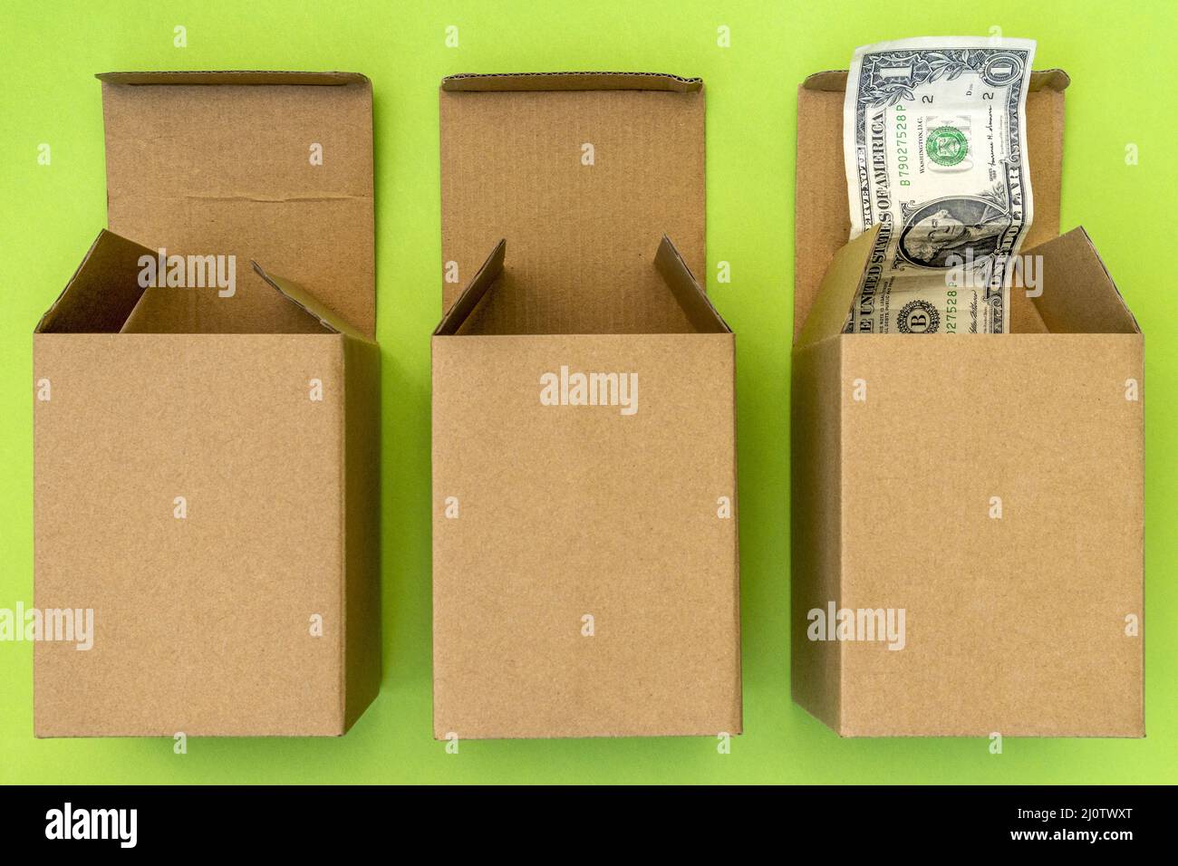 Three open boxes and dollar bulging out of one of them Stock Photo - Alamy