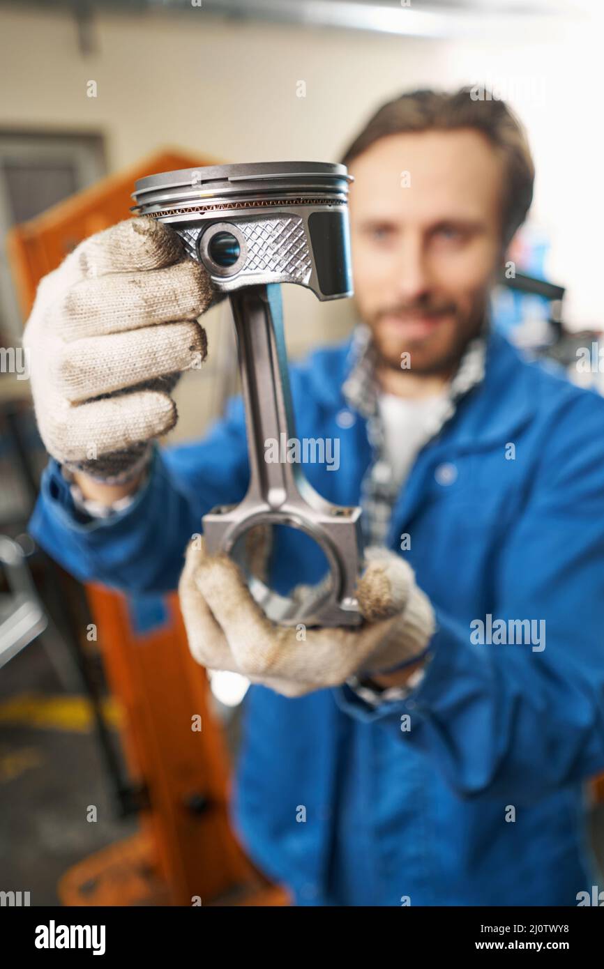 Male holding car part in his hands Stock Photo - Alamy