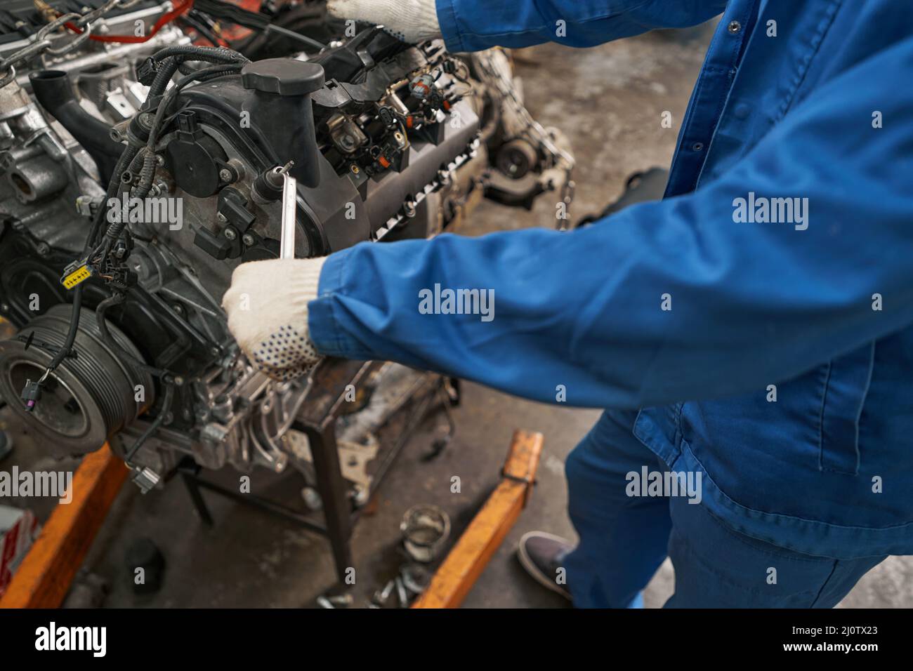 Mechanic holding tool in hands and repairing Stock Photo - Alamy