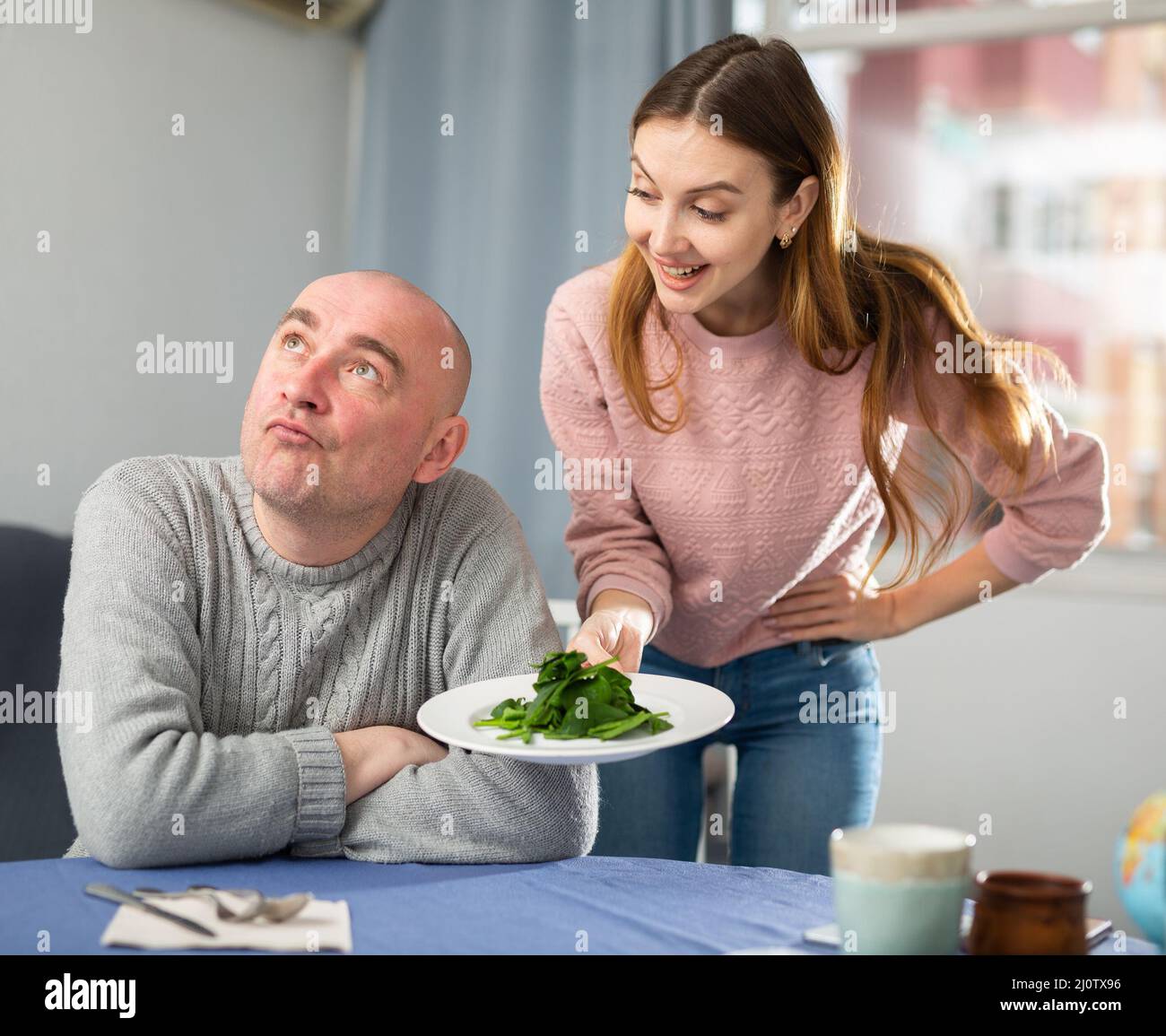 Man dissatisfied by dinner made by his wife Stock Photo - Alamy