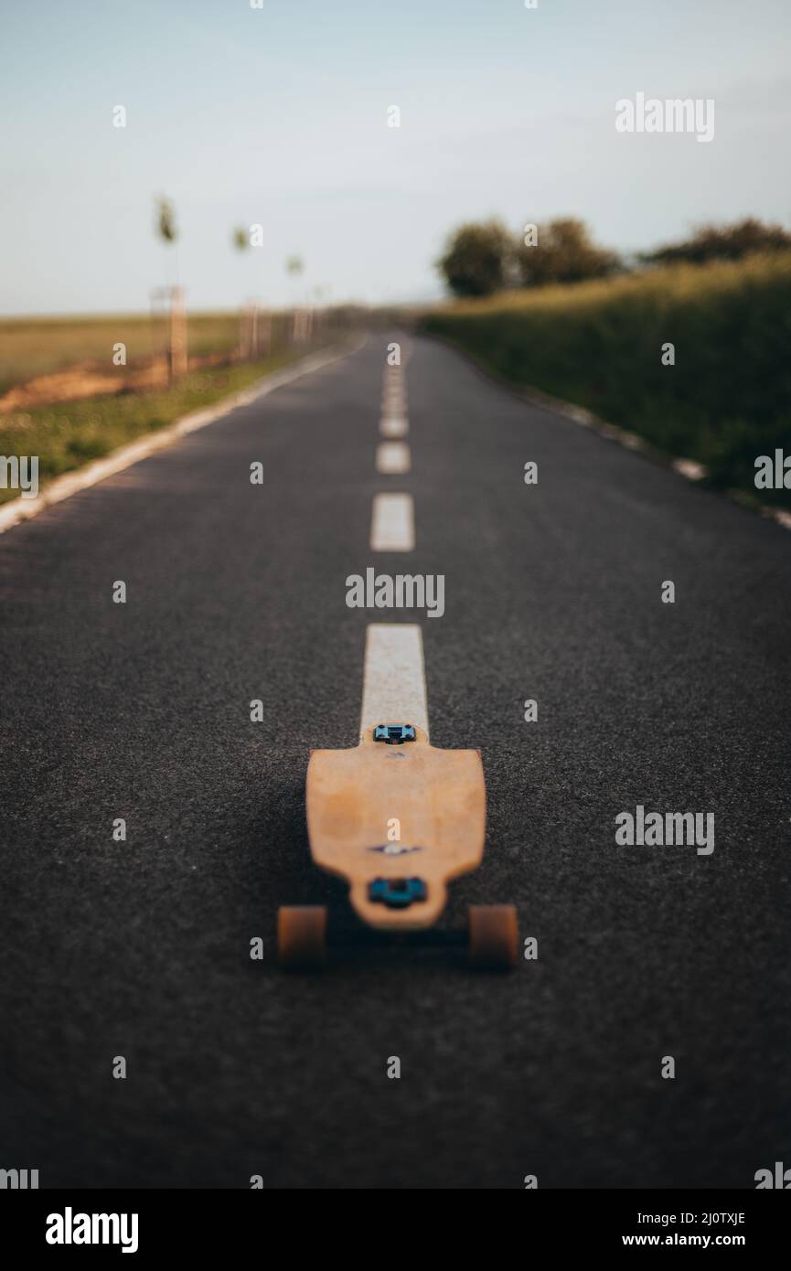 Longboard in the middle of the road without a figure. copy space ...