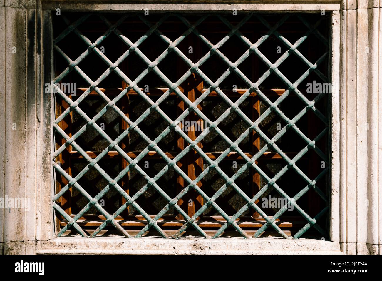 Rectangular metal lattice in front of a window on the facade of the ...