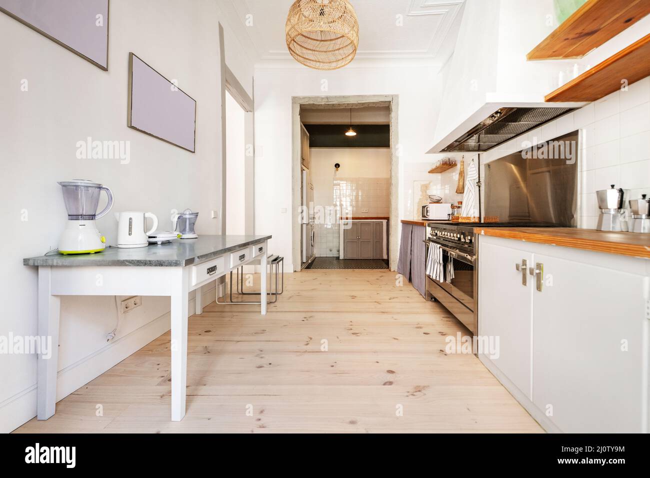 Kitchen with vintage wood and brick furniture, large metal gas stove ...