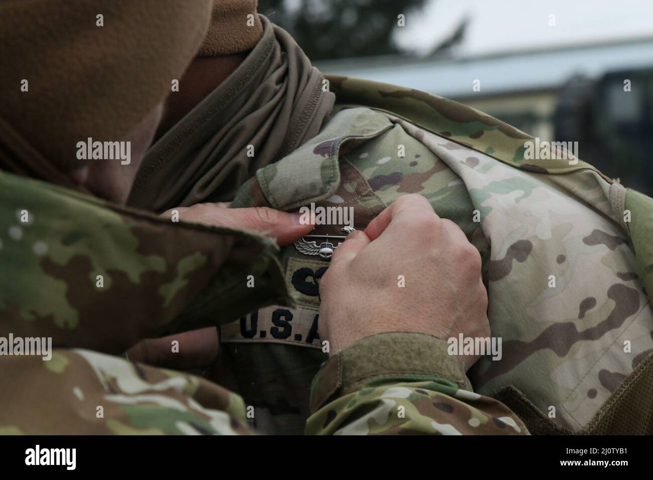 Air assault instructors pin the air assault wings onto their students ...