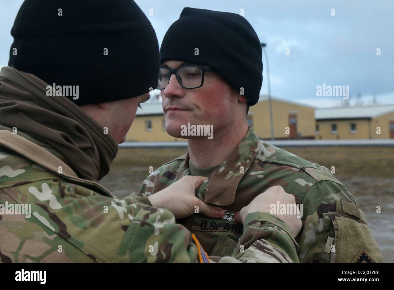 Air assault instructors pin the air assault wings onto their students ...