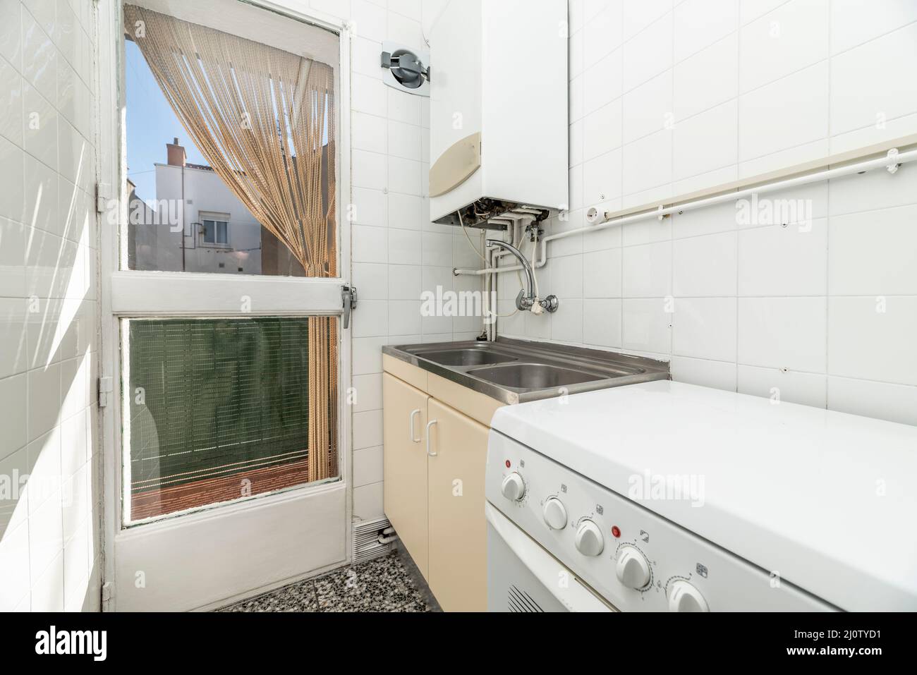 old kitchen with wooden door to a terrace, natural gas heater and ...