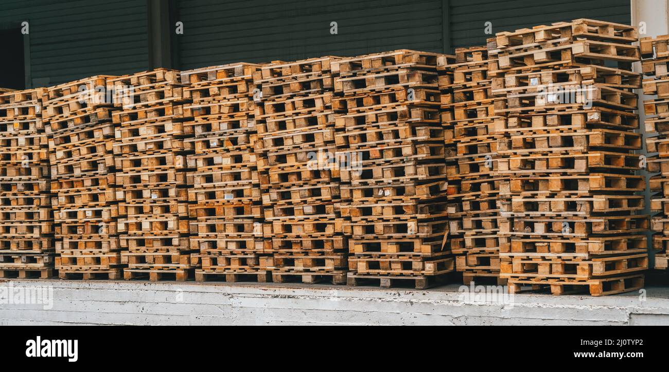 Stacks of wooden pallets in warehouse outdoor storage for industrial ...