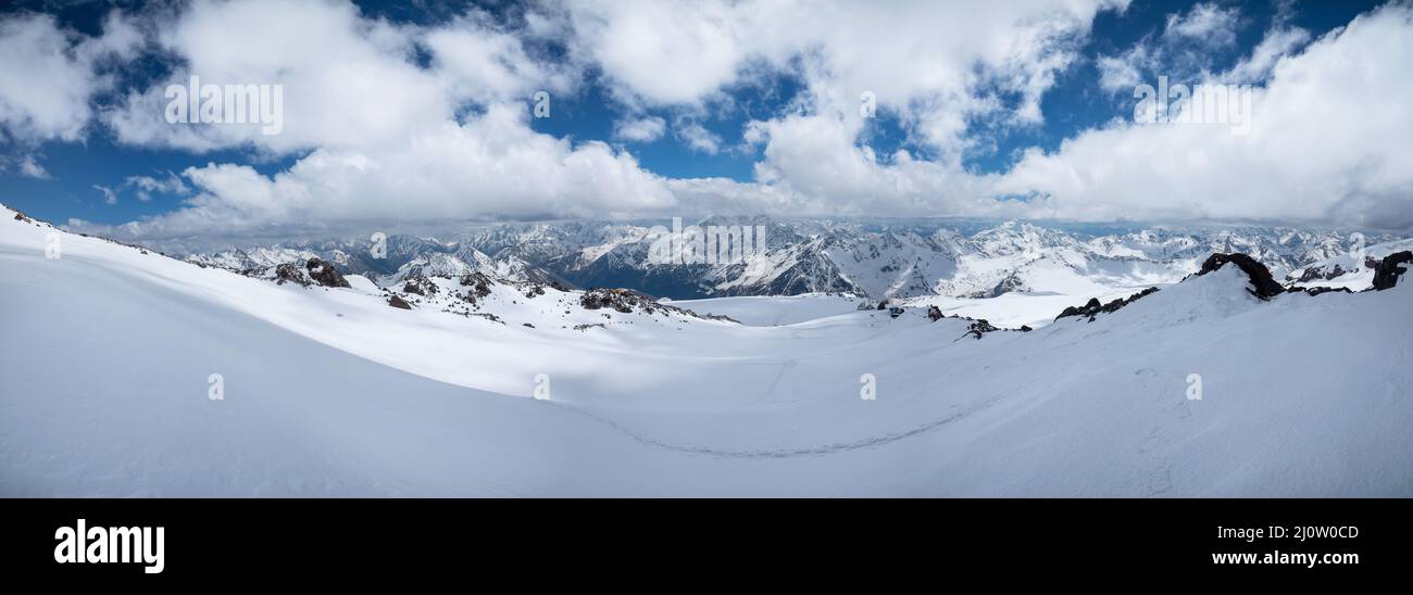 Alpine panorama of the large Caucasian ridge covered with snow on a ...