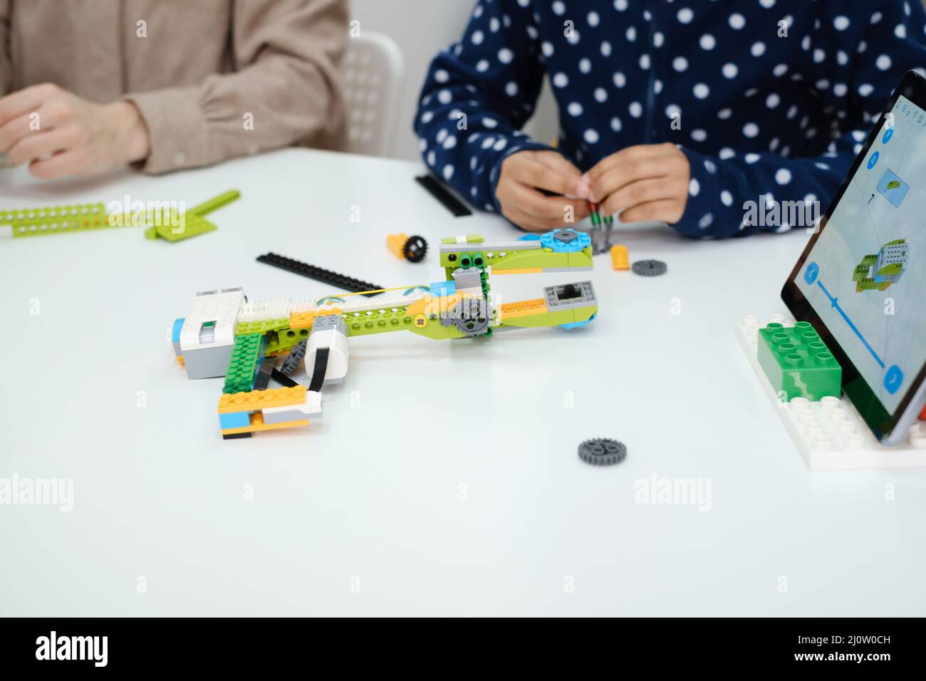 Coding Class, school girl constructing robot arm mechanism. multiethnic ...