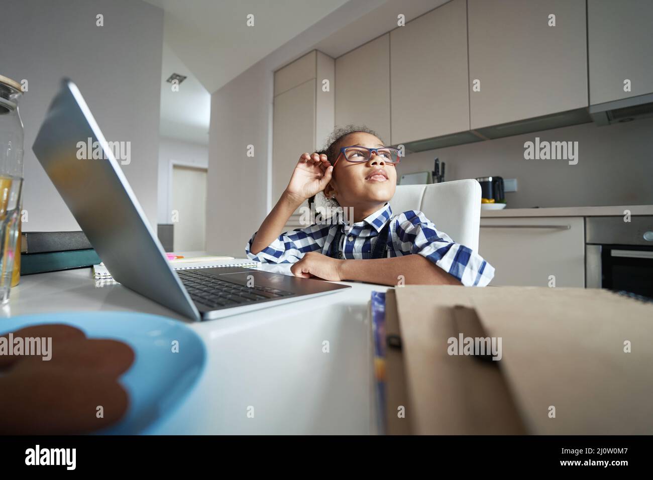 Young girl getting distracted from her computer Stock Photo - Alamy