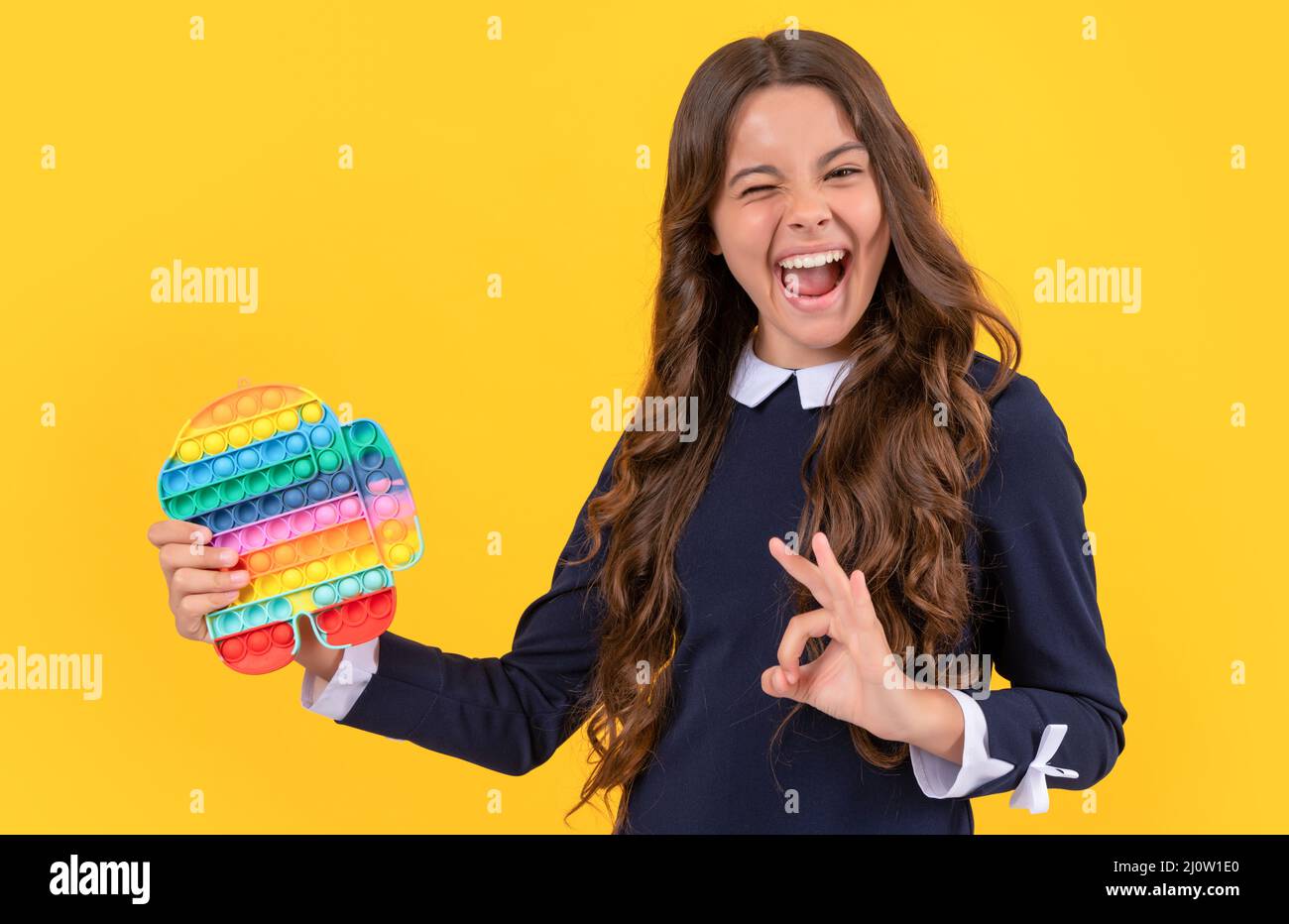 ok. winking child presenting color popit fidget. push button antistress ...