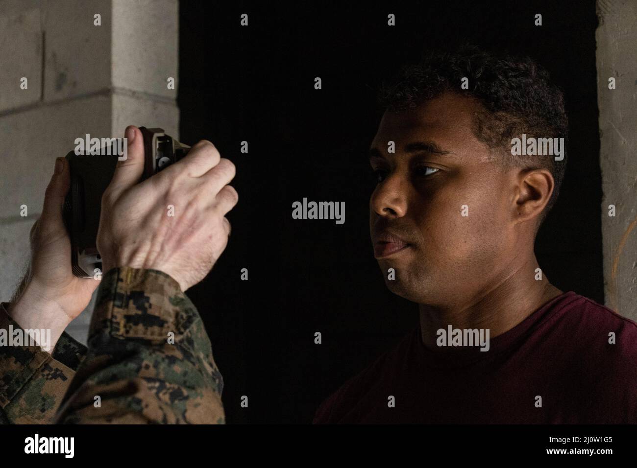 A U.S. Marine with the 31st Marine Expeditionary Unit (MEU), looks into ...