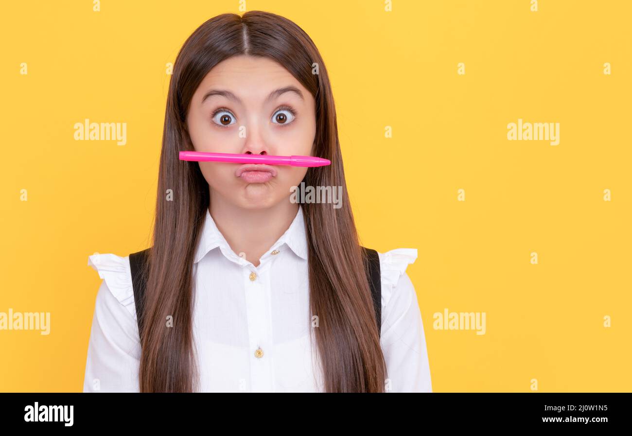 Funny school child hold pen as mustache yellow background, education ...