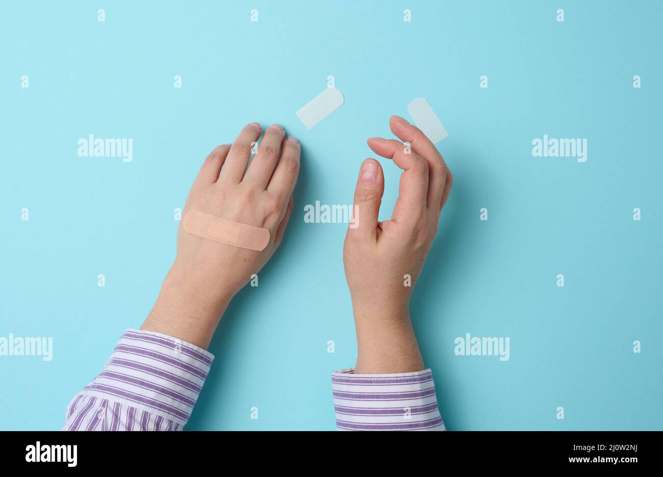 Female hand and brown medical adhesive plaster for the treatment of ...