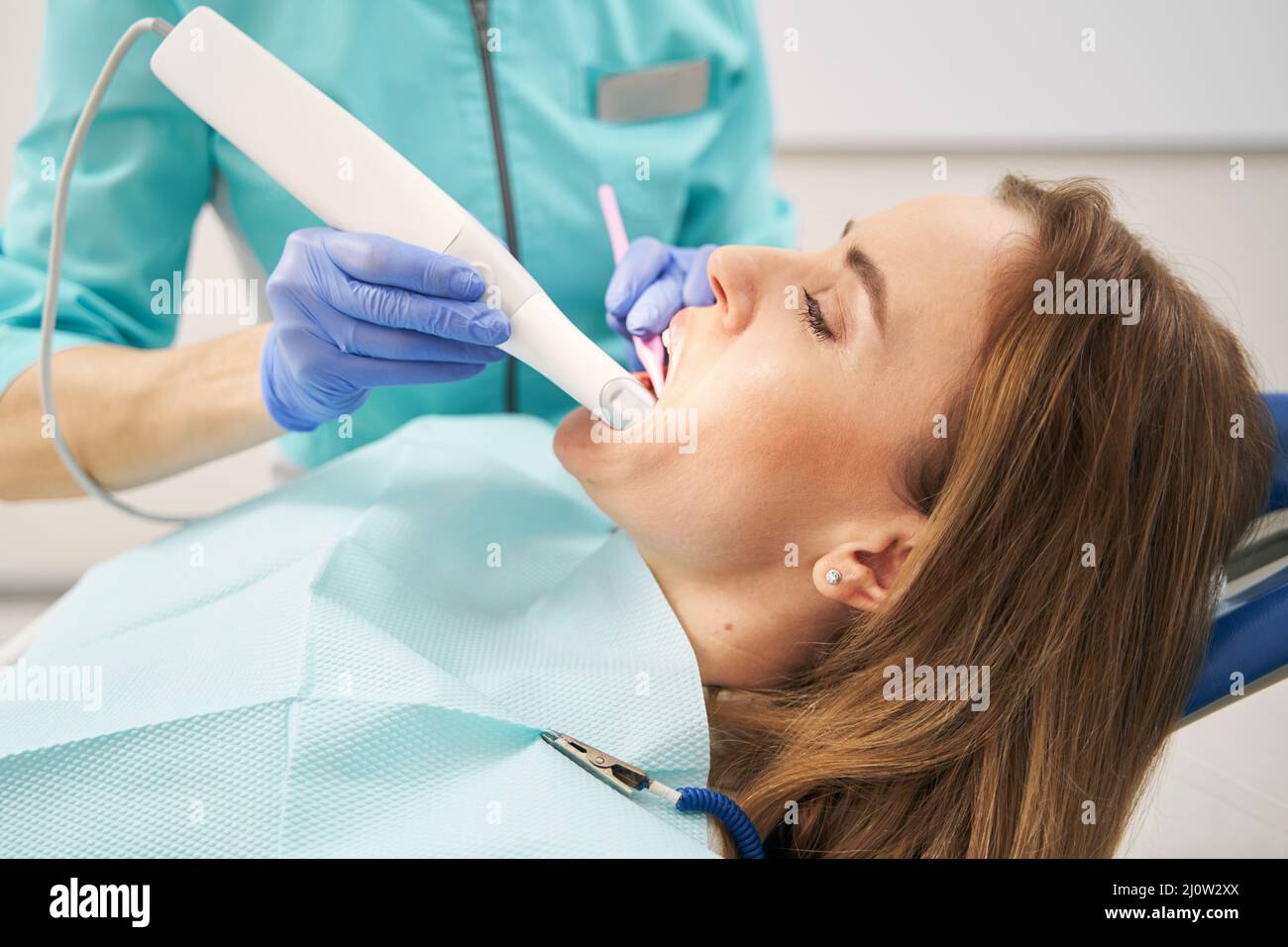 Dentist examining female teeth with dental 3D scanner Stock Photo - Alamy