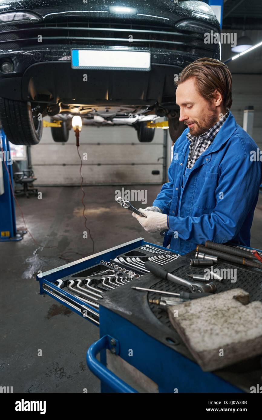 Portrait of car mechanic working at service station Stock Photo - Alamy